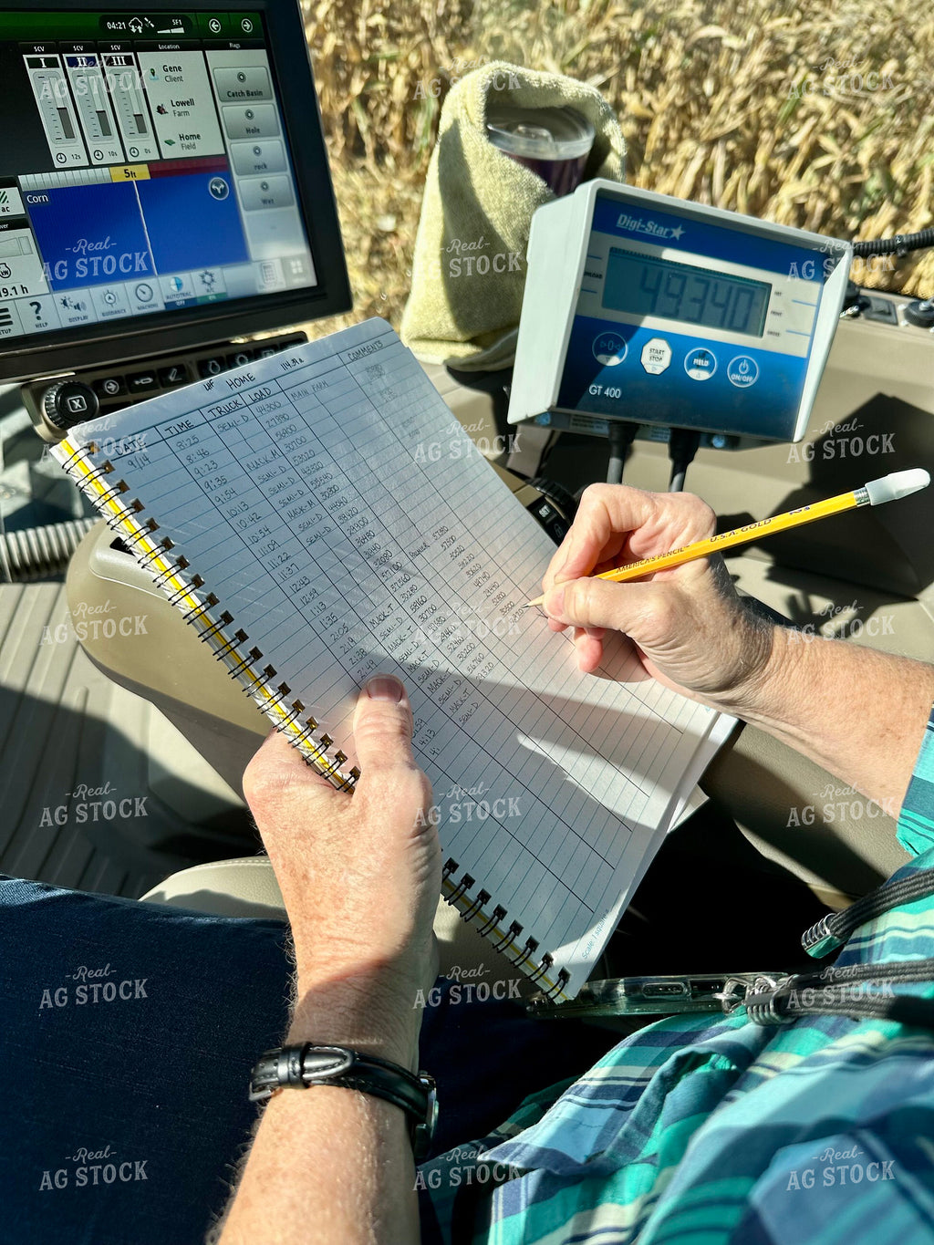 Farmer Filling out Grain Log Sheet 277008 – Real Ag Stock
